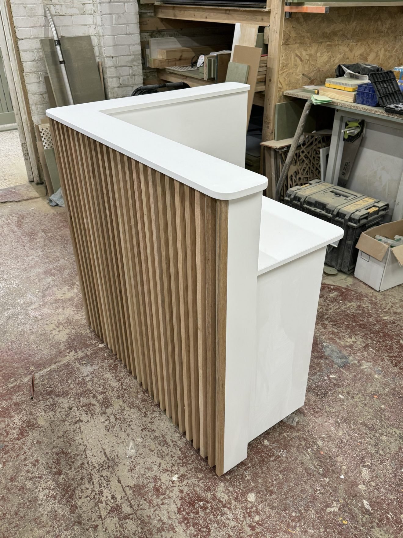 L-Shaped Reception Desk with Oak Slats and Cupboard